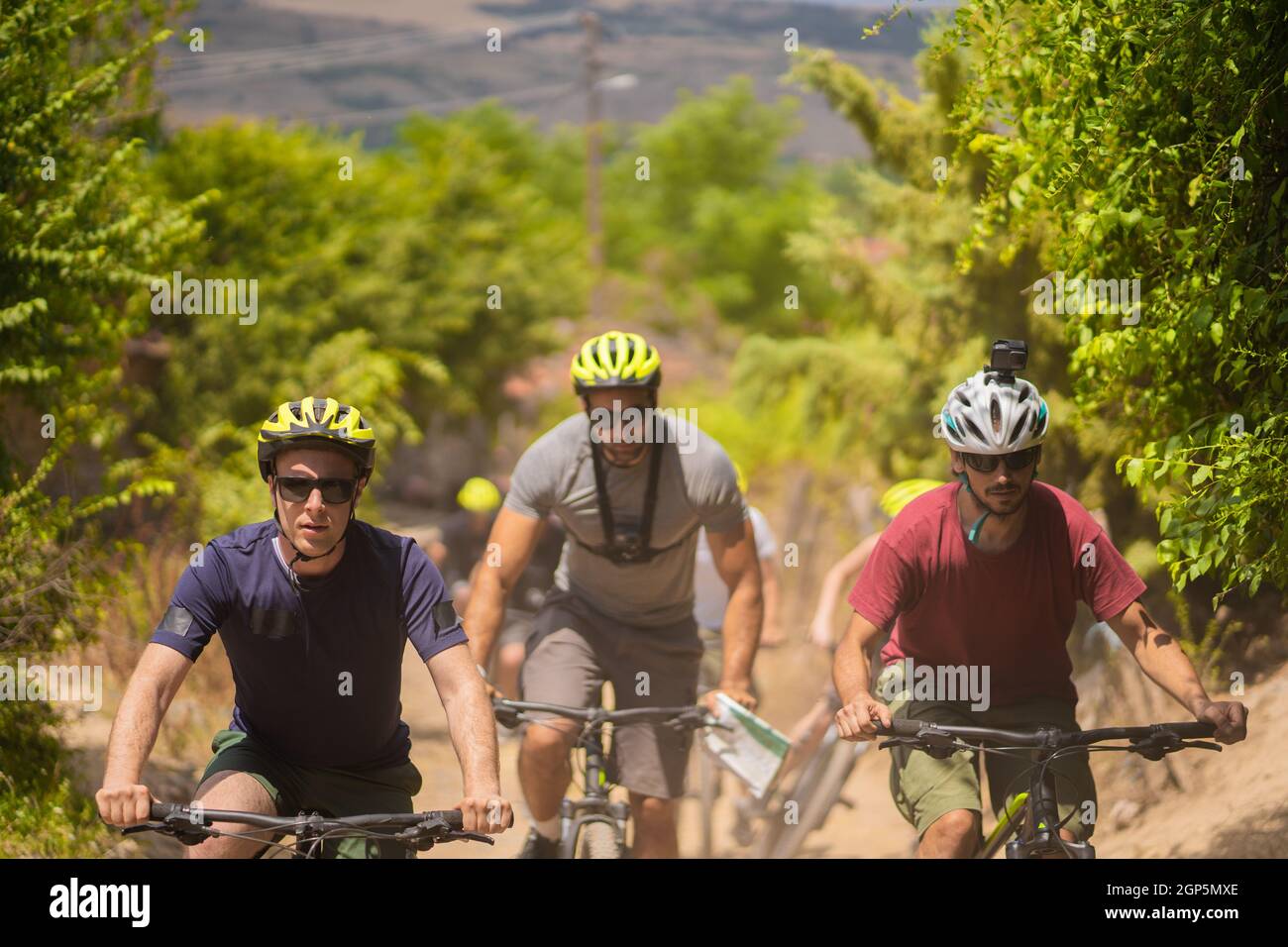 Group of friends on biks are racing each other while making a big fog ...