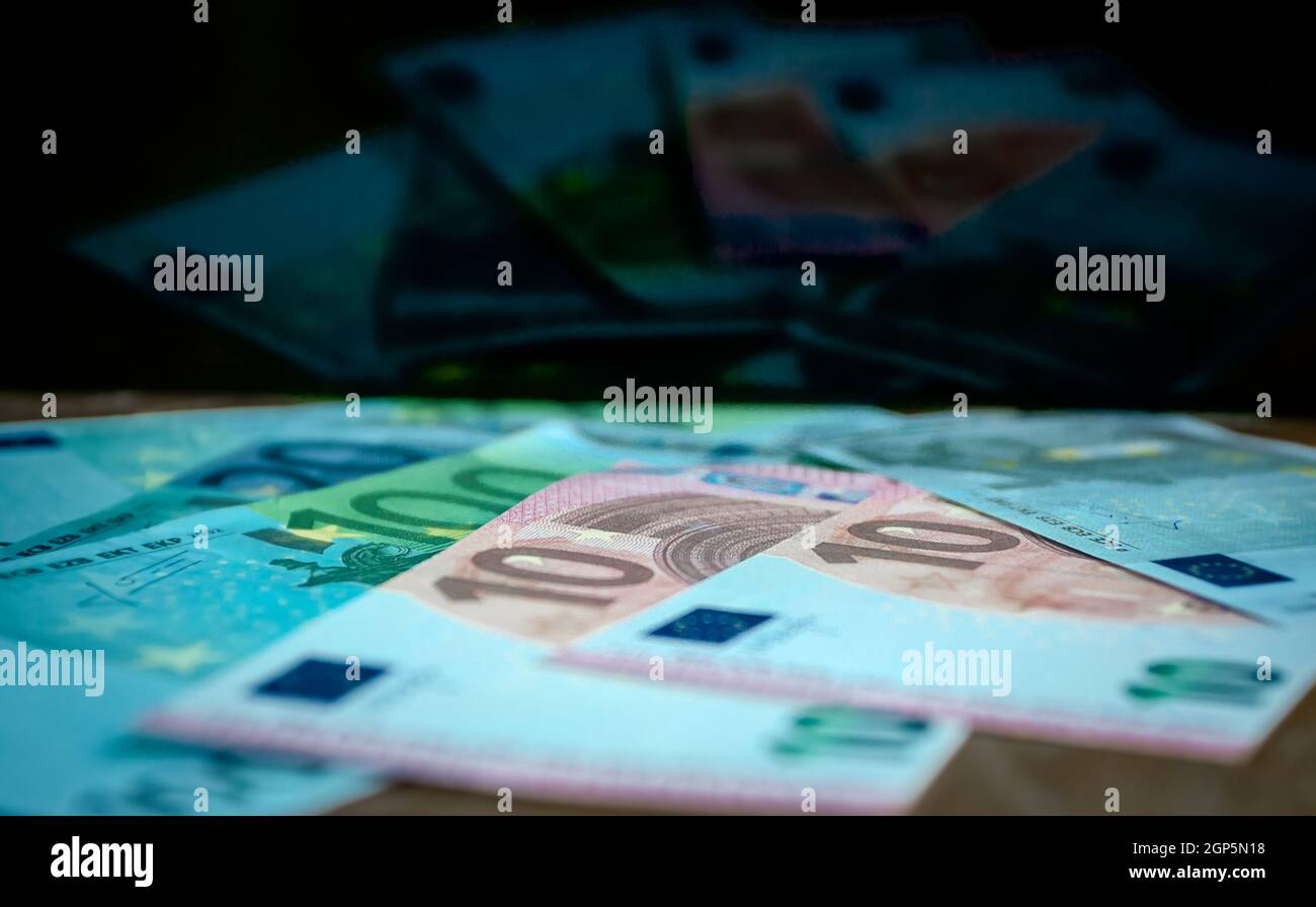 Close-up of a group of euro bills arranged on top of each other on a ...