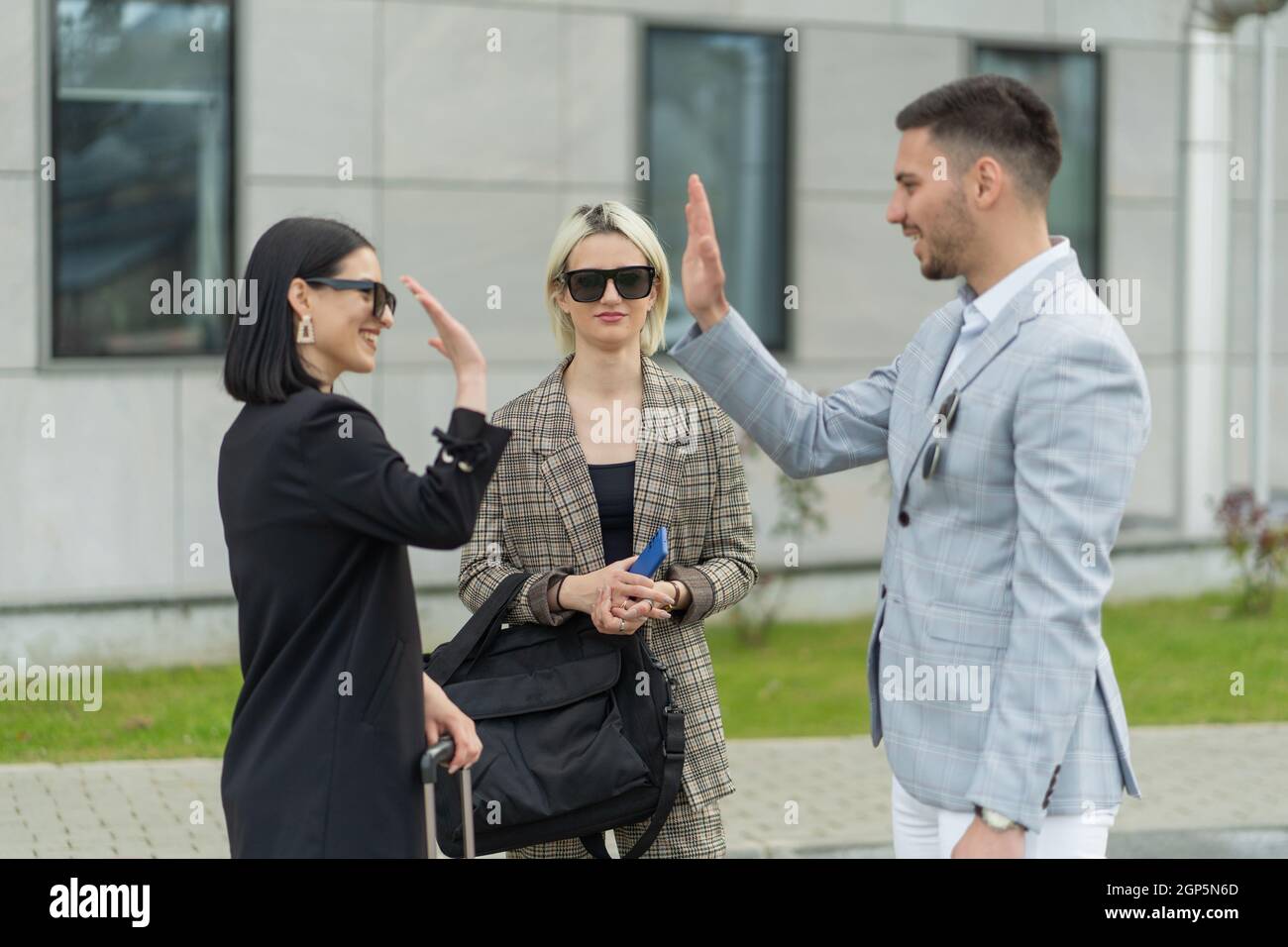 Business people are giving each other high five for the deal they just made Stock Photo - Alamy