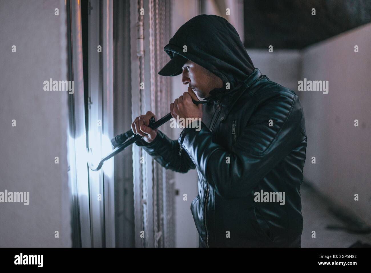 Burglar entering through window hi-res stock photography and images - Alamy