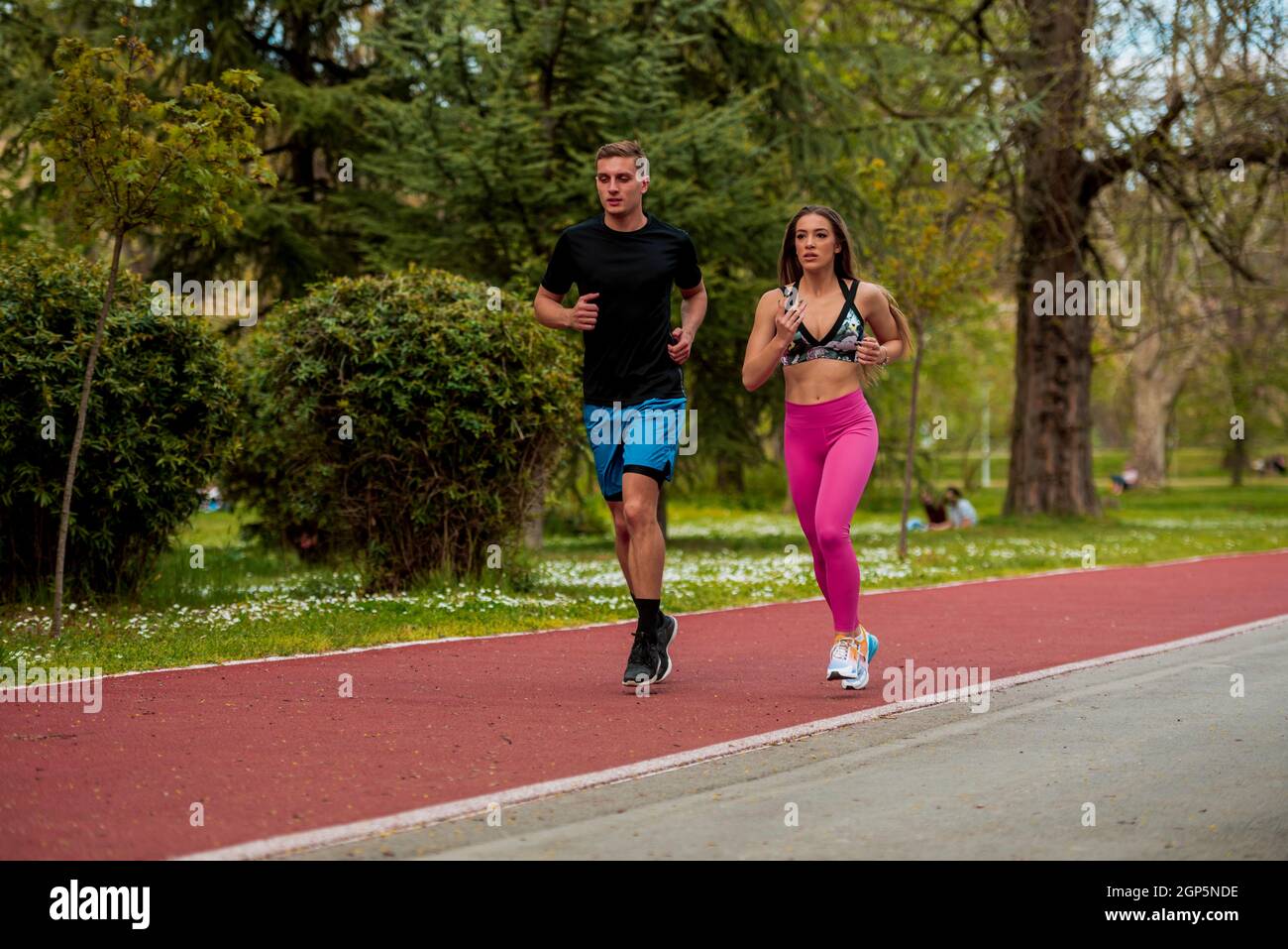 Young couple running together outdoors in beautiful landscape. Woman ...