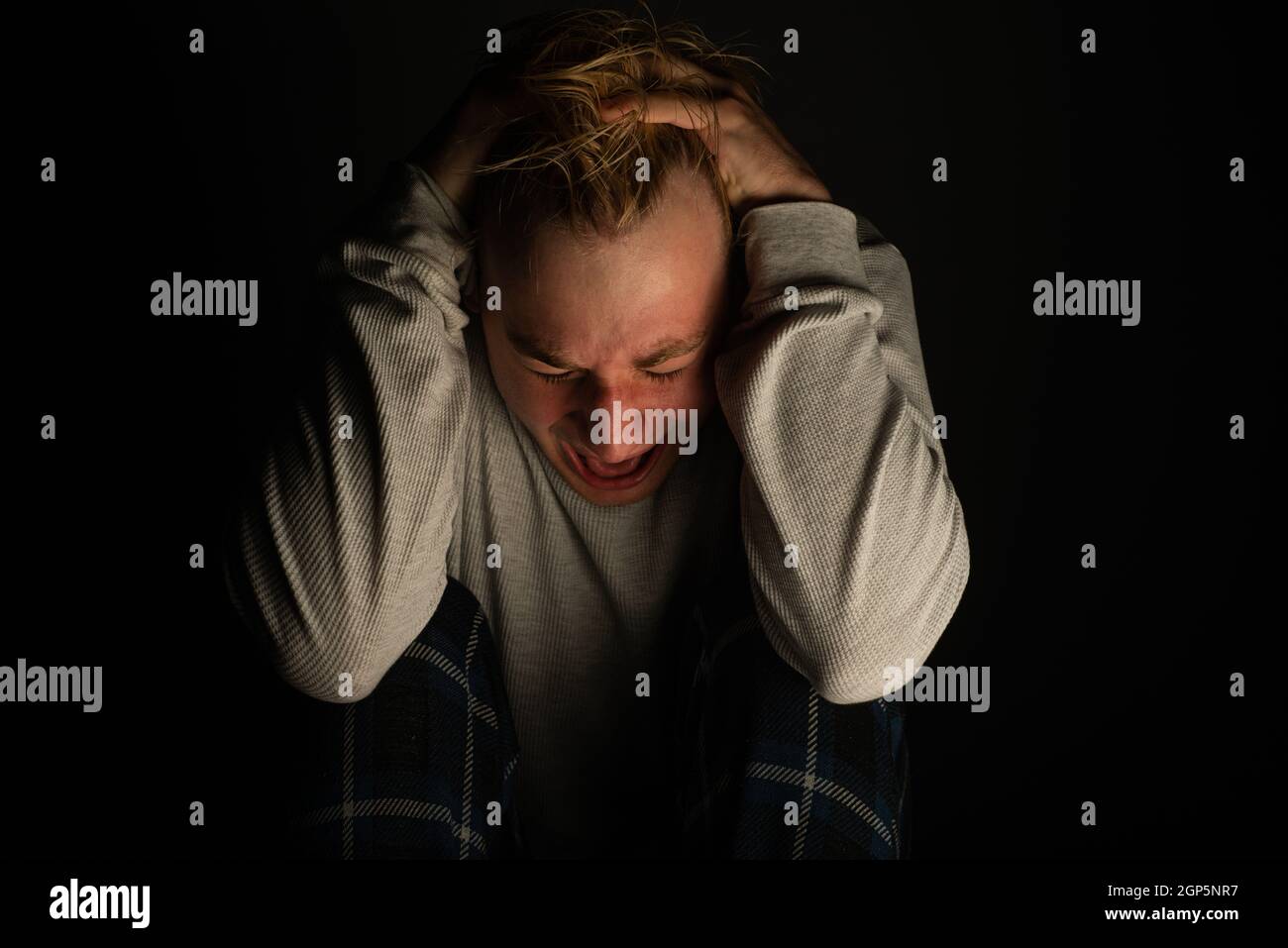 Broken boy is having so much pain in his scream Stock Photo - Alamy