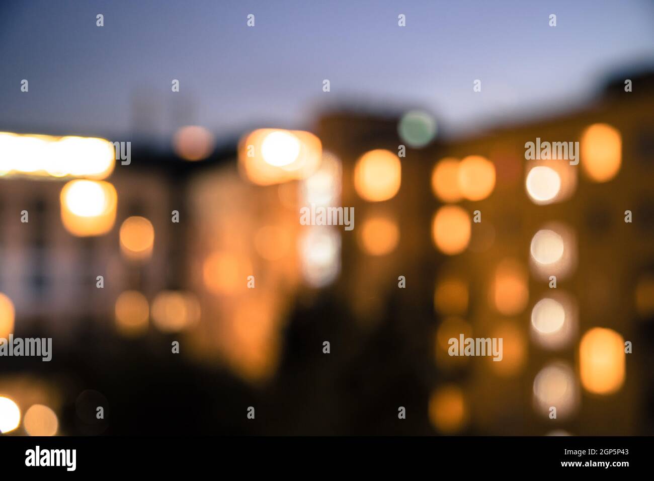 Blurry apartment block at dusk, urban city life, lights Stock Photo - Alamy