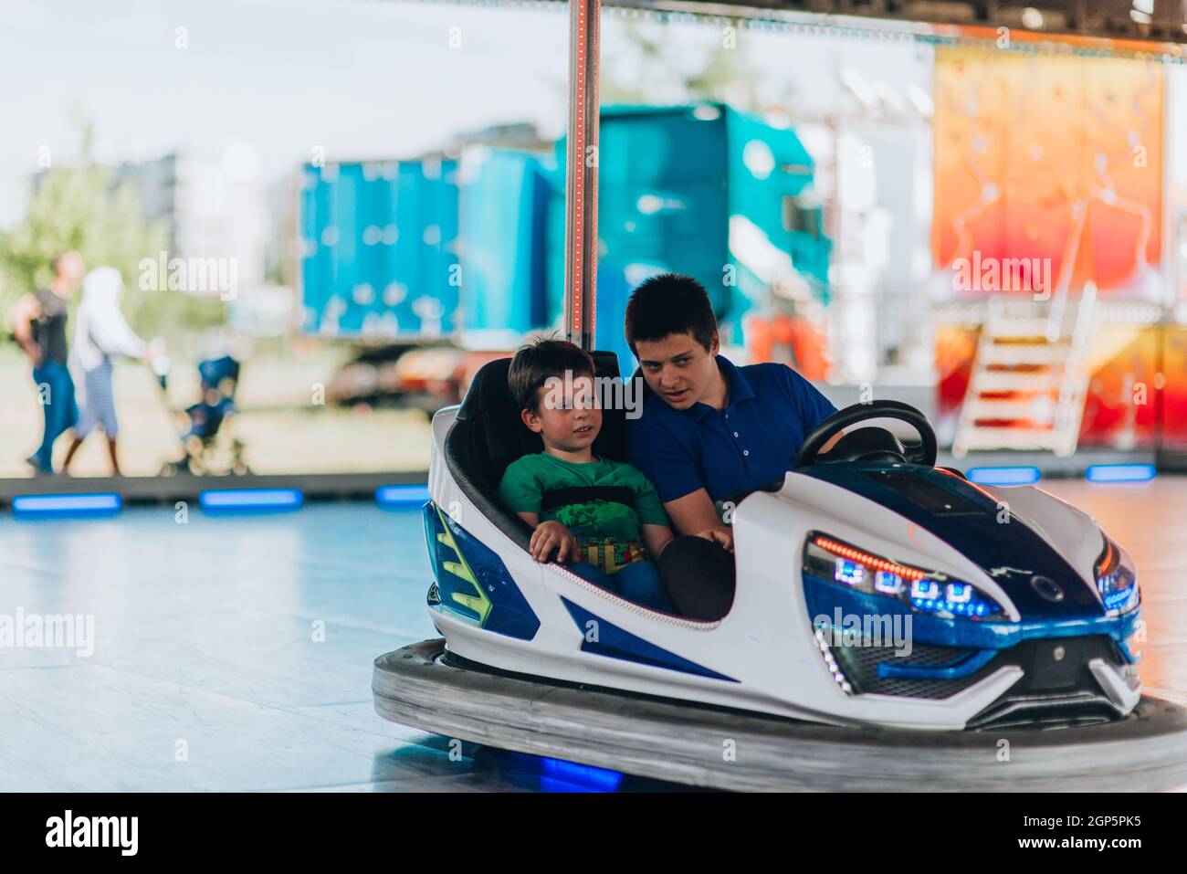 Happy little kids having fun on outdoor amusement park Stock Photo - Alamy