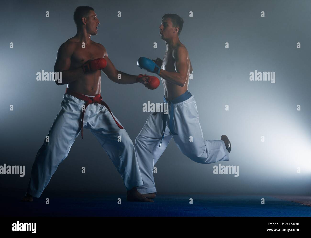 Karate men posing on a dark background wearing white kimono Stock Photo ...