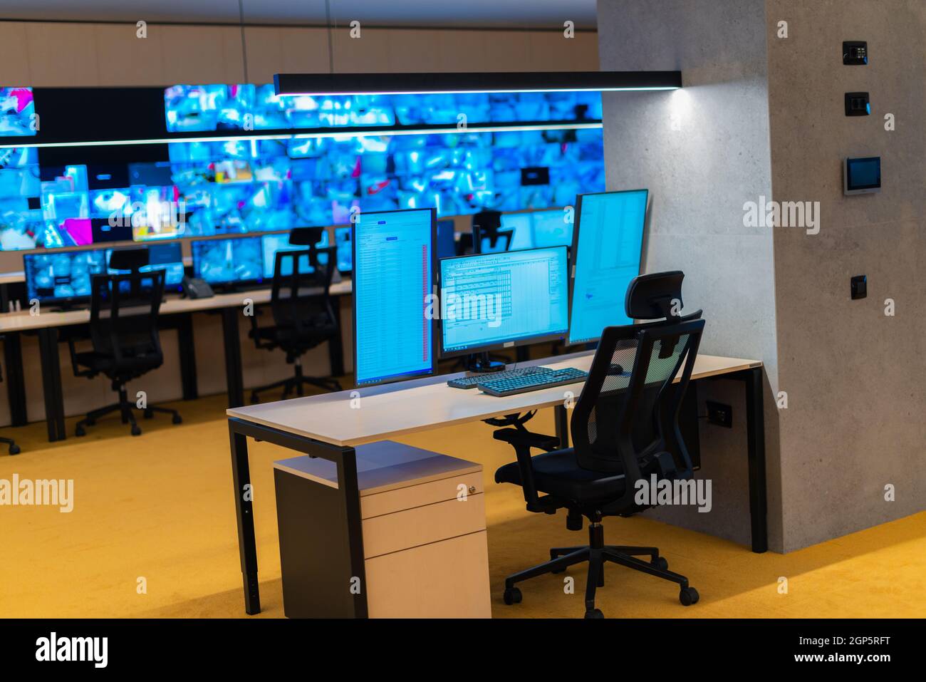 Empty office, desk, and chairs at a main CCTV security data center ...
