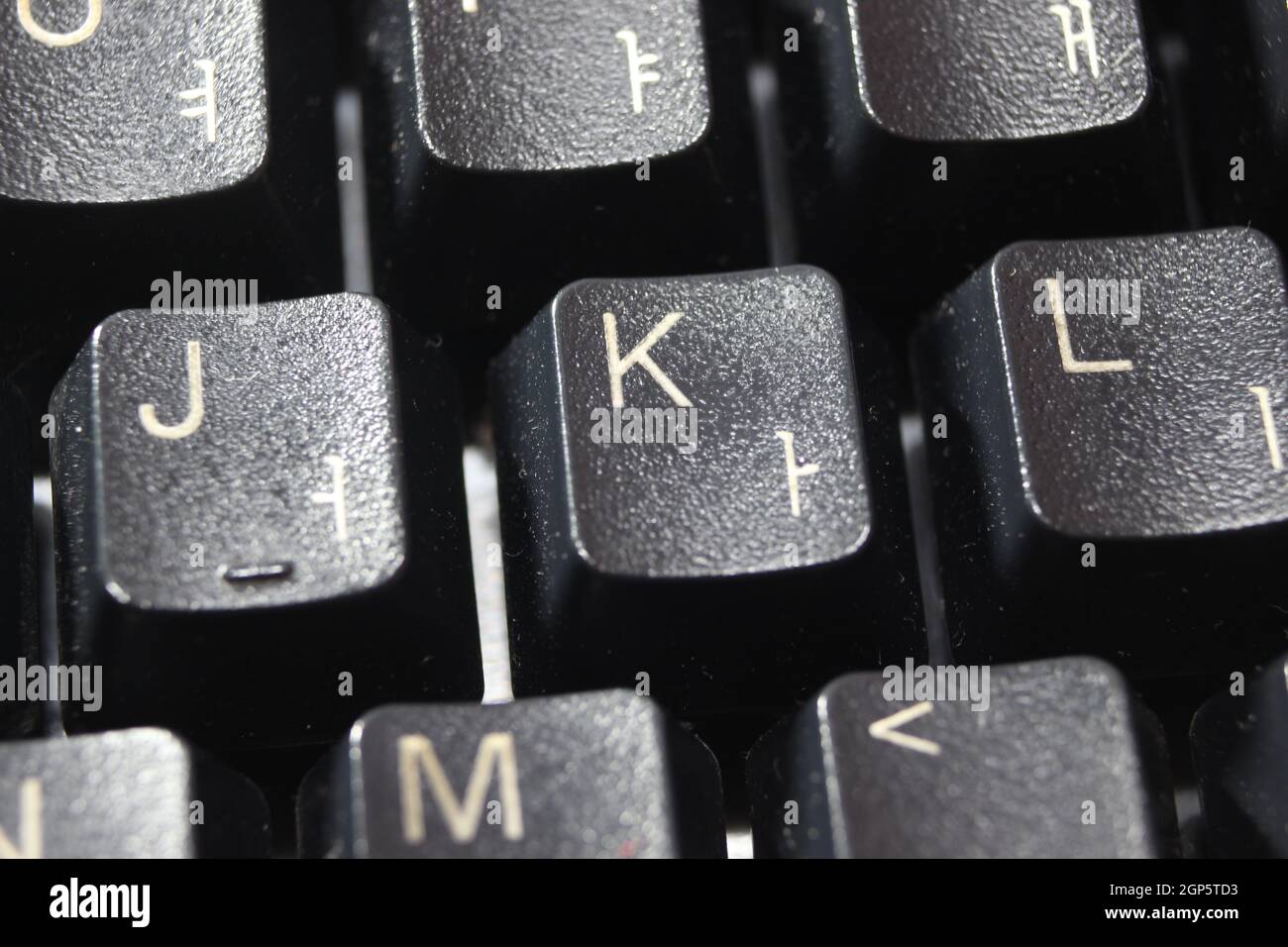 Closeup of laptop computer keyboard black keys with white letters and ...