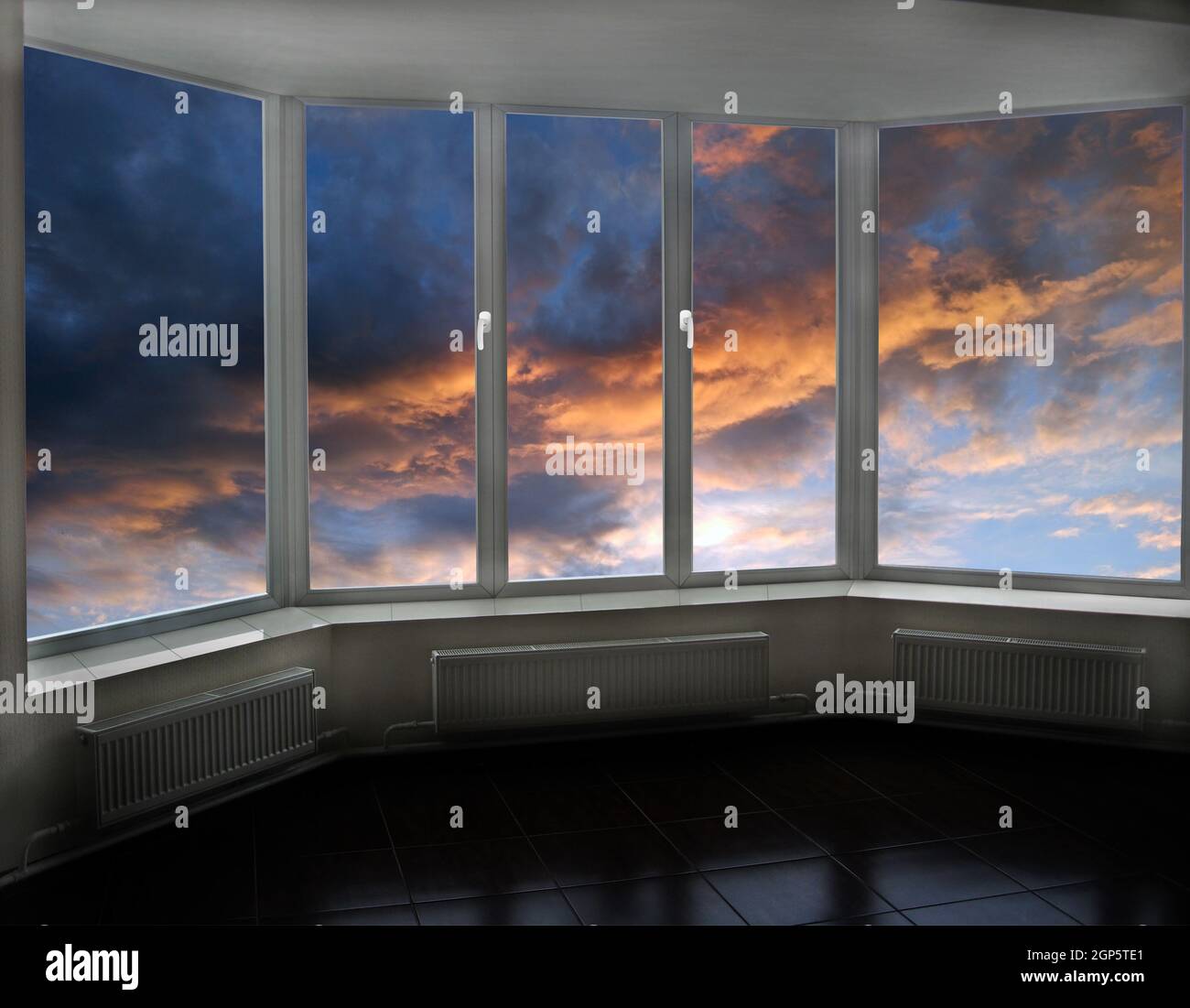 Window with view to sunset with dark cloud. Thunder-storm clouds ...