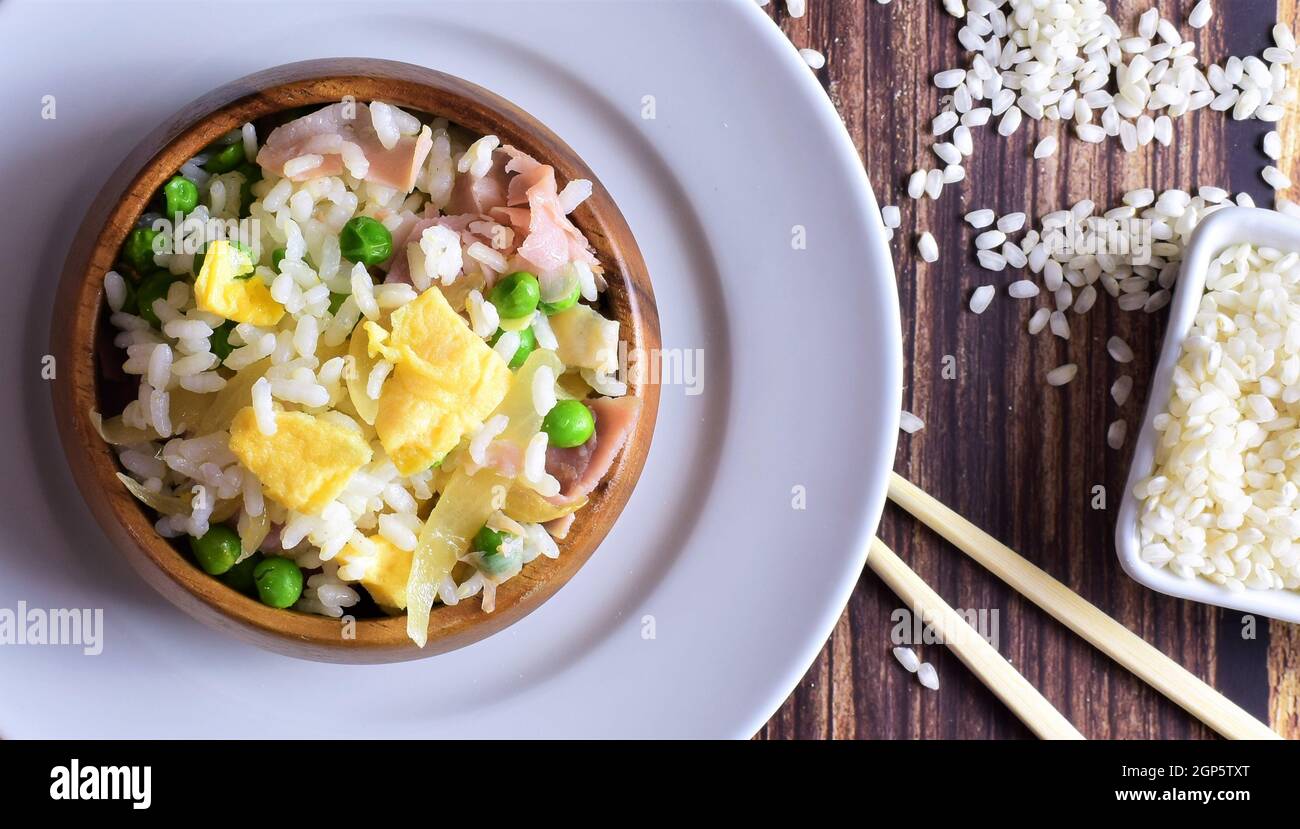 Top view shot of a plate full of rice three delights, and chopsticks on ...