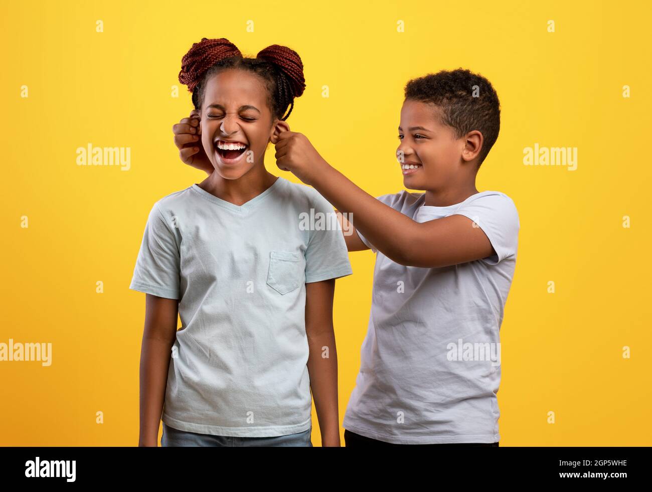 Siblings fights, quarrels, relationships concept. Naughty black boy ...