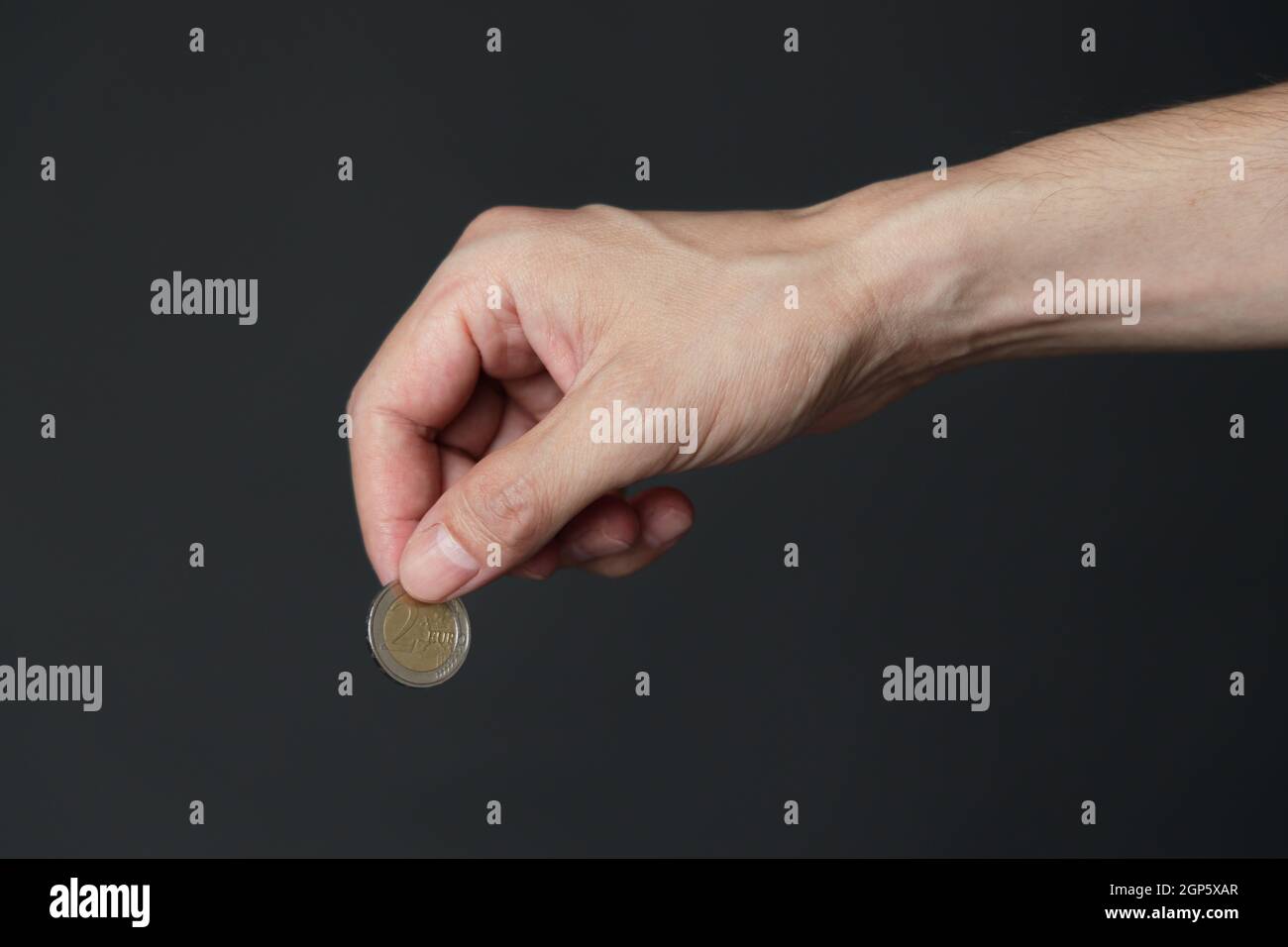 Hand ready to drop a coin. Saving and investment concept Stock Photo ...