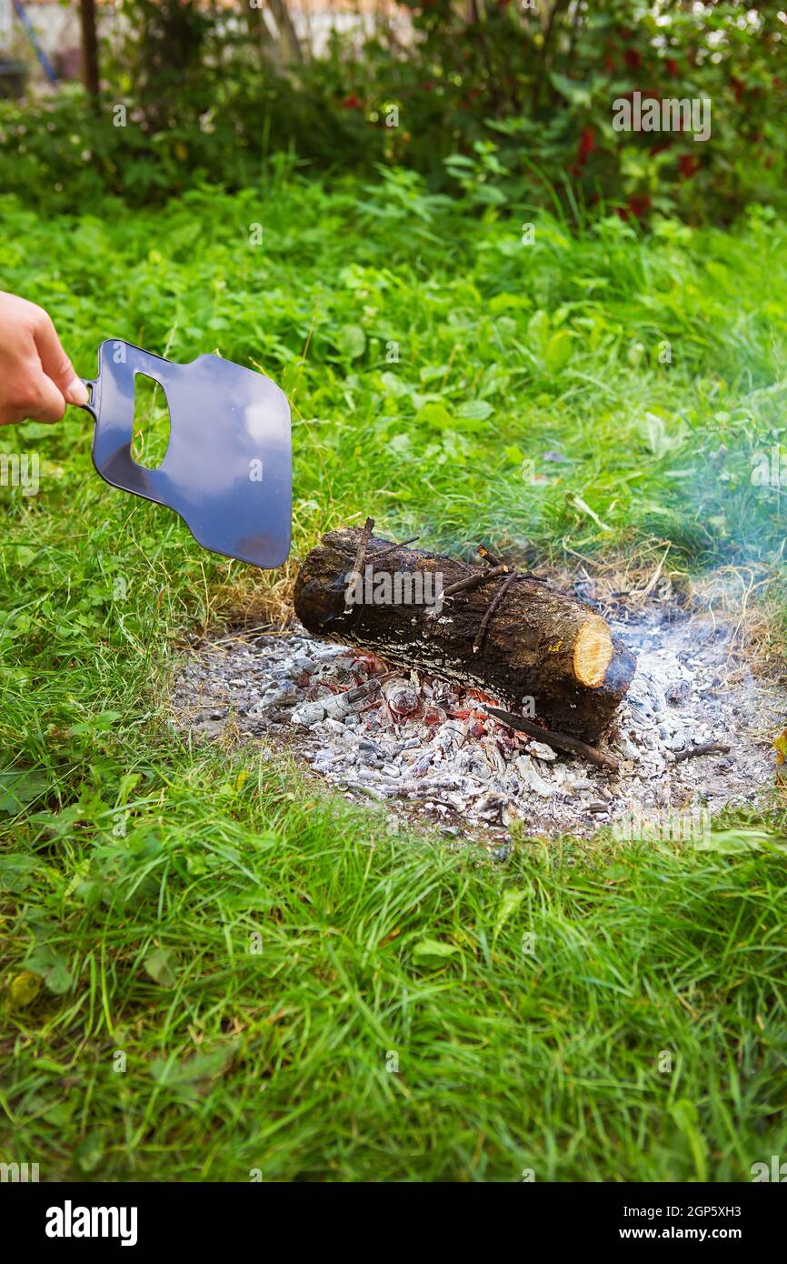 Burning fire in the evening, summer beautiful warm evening. The process ...