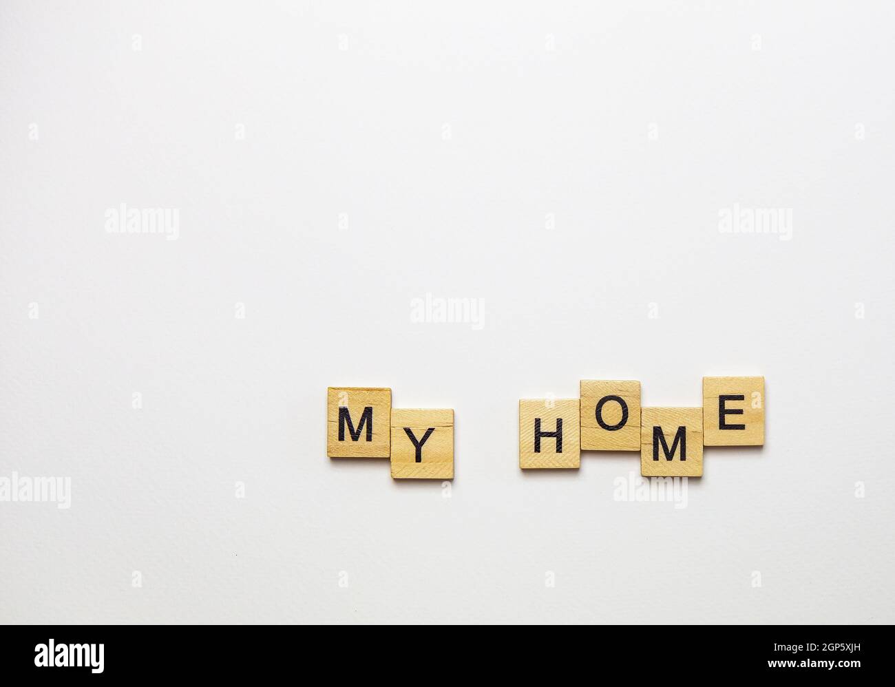 Text my home lined with wooden cubes on white background Stock Photo ...