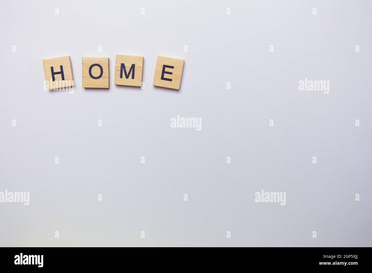 Decorative wooden letters forming the word home on a white background ...
