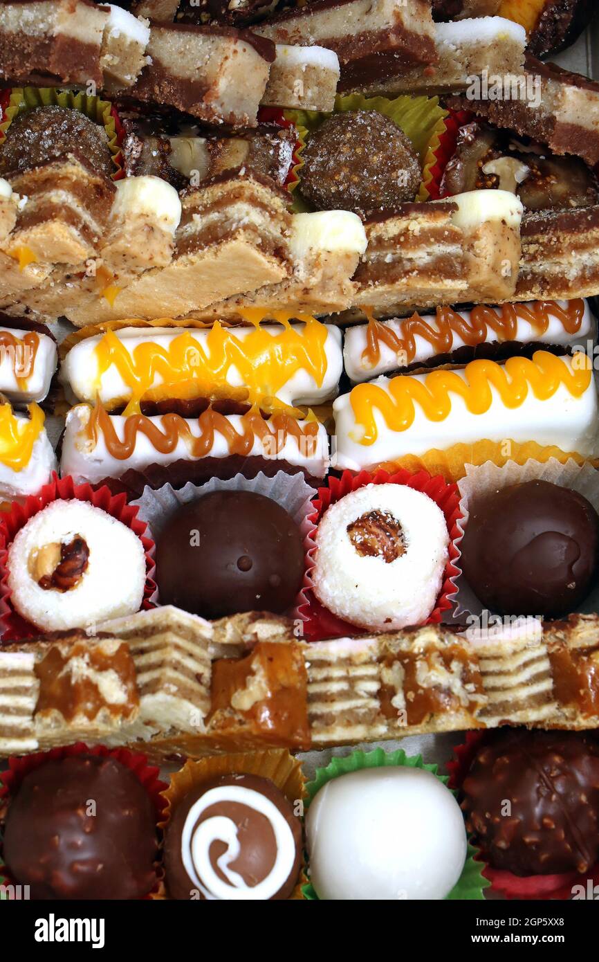 Background of large piles of sweet cake pieces in different tastes and ...