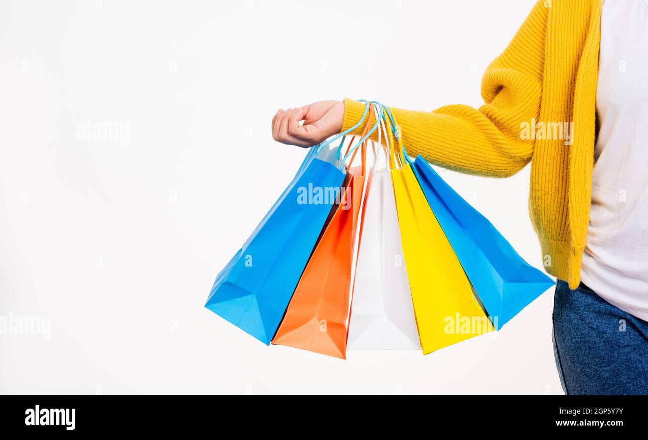 Happy woman hand she wears yellow shirt holding shopping bags ...