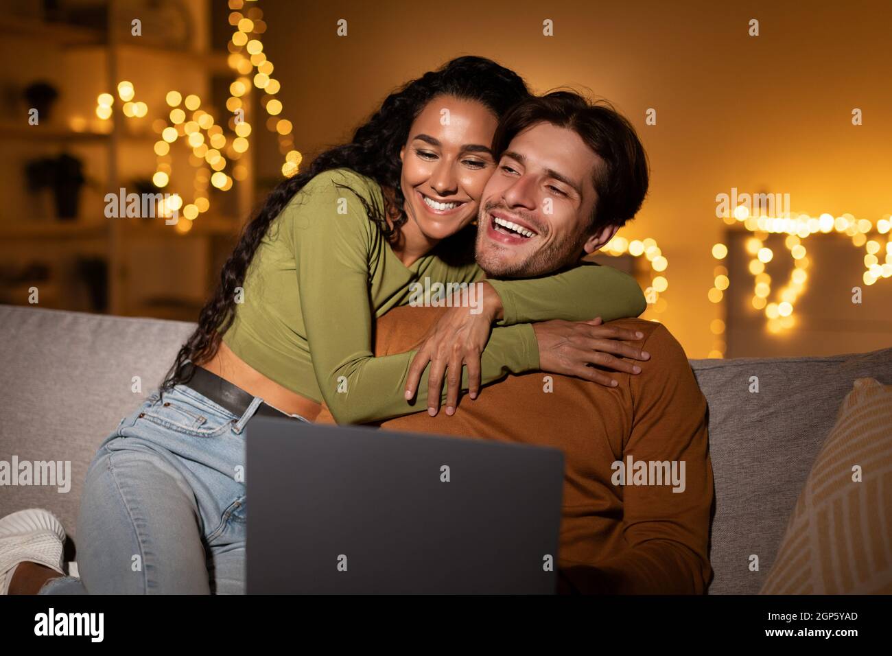 Lovely Couple Embracing Browsing Internet On Laptop Computer Spending ...