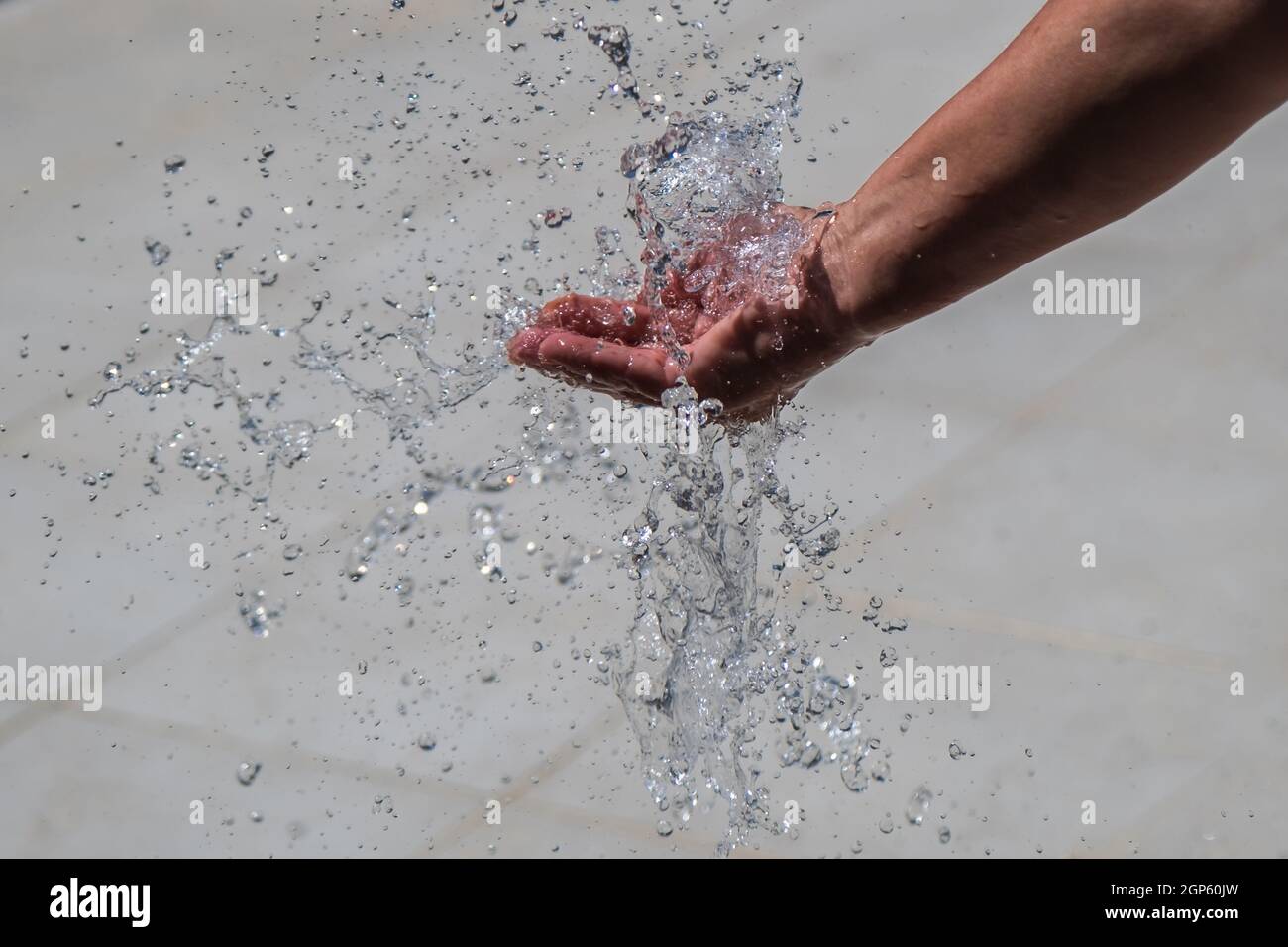 Human hand with water splashing on it Stock Photo - Alamy
