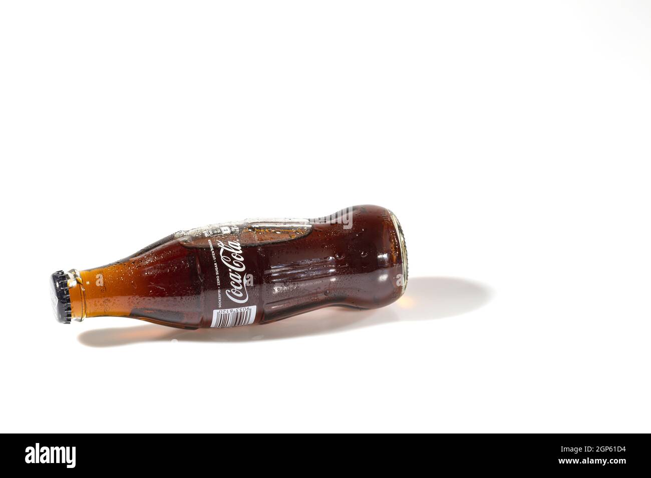 Close up view of lying Coca Cola in glass bottle isolated on white ...