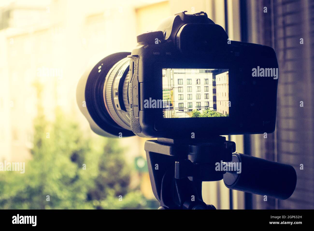 Professional with telephoto lens on tripod, surveillance and stalking ...