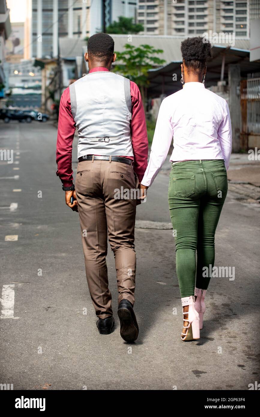 Back view couple walking arms hi-res stock photography and images - Alamy