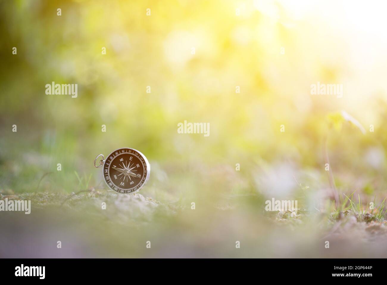 Vintage compass lying on the floor. Adventure and discovery concept ...
