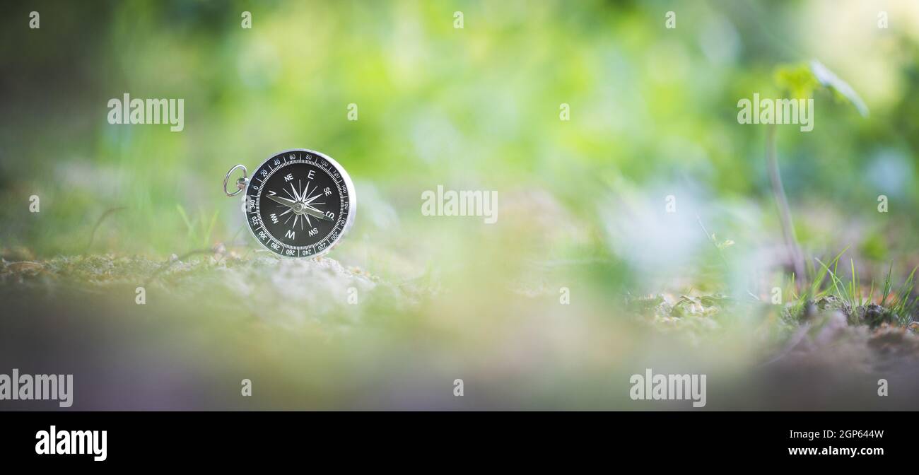 Vintage compass lying on the floor. Adventure and discovery concept ...