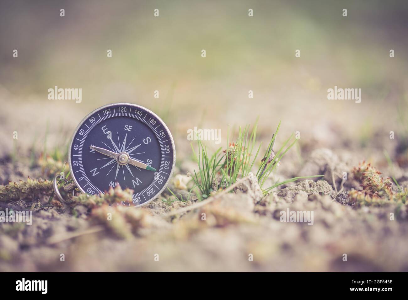 Vintage compass lying on the floor. Adventure and discovery concept ...