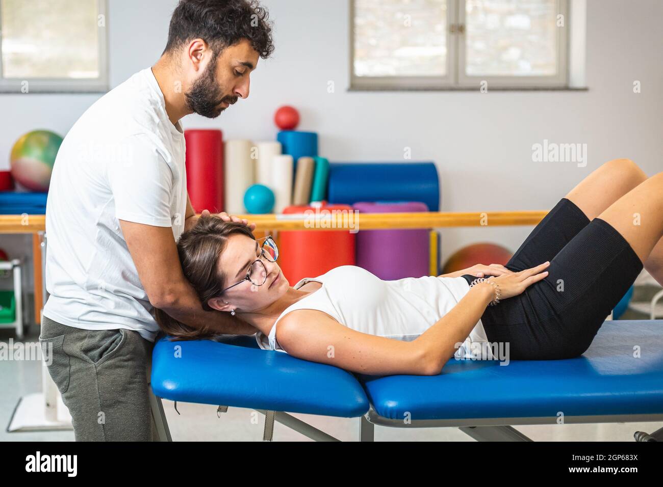 Physiotherapist doing manual stretching and resistance techniques to ...