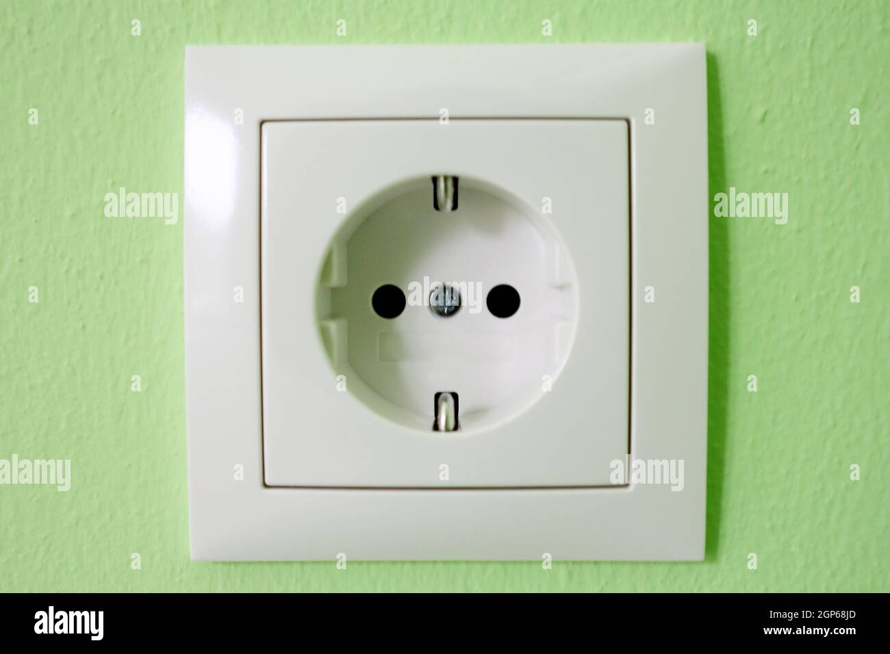 white electrical wall socket with green background detail Stock Photo ...