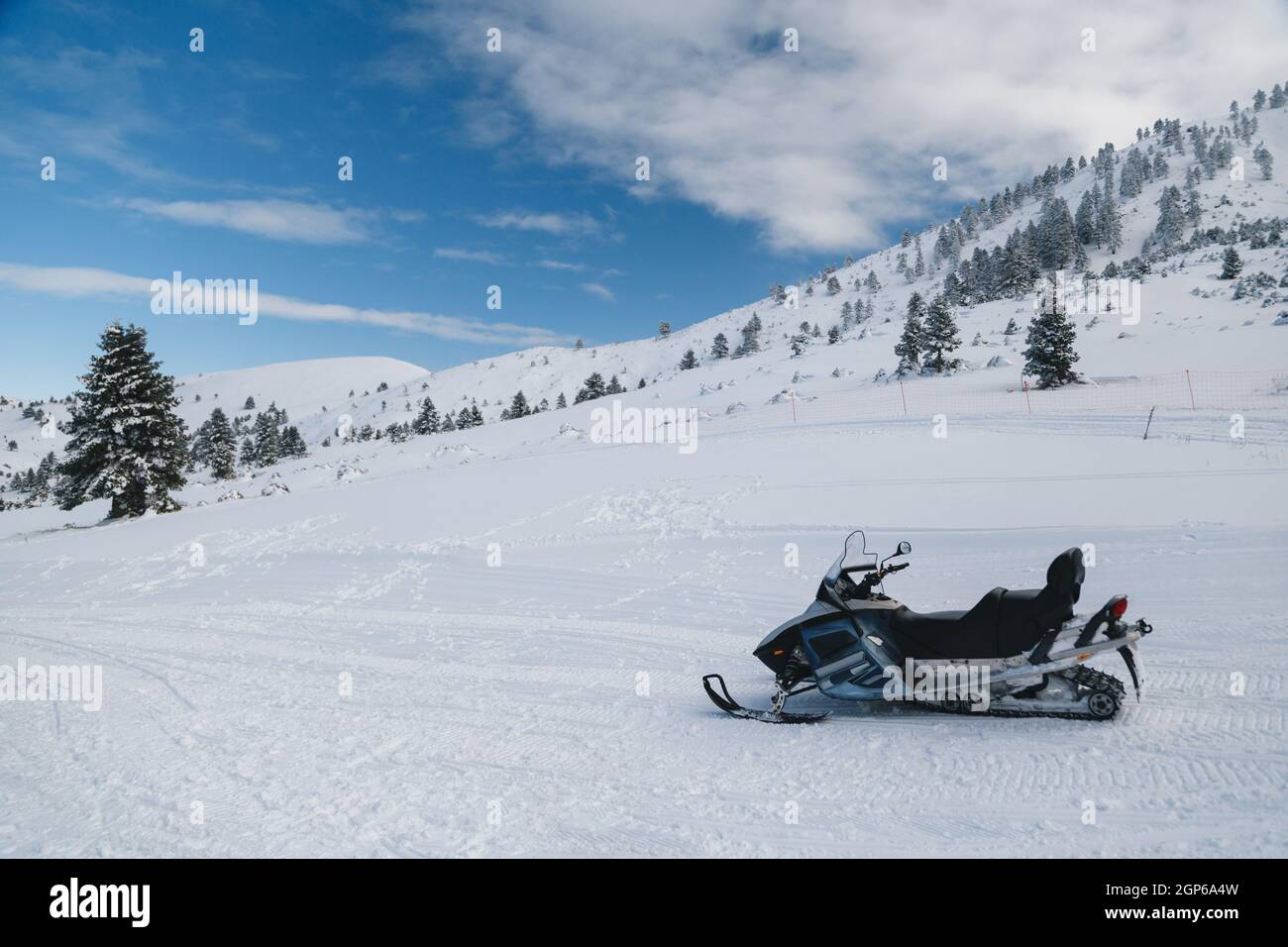 Snowmobile without people on ski slope with splendid snow-covered ...