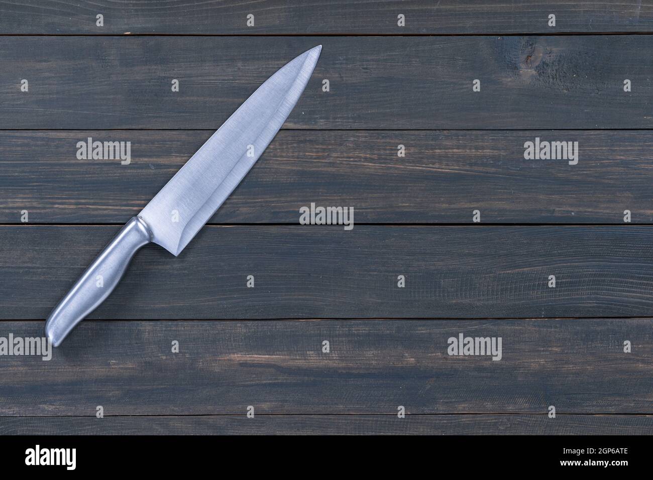 Close up kitchen knife on a wooden table Stock Photo - Alamy