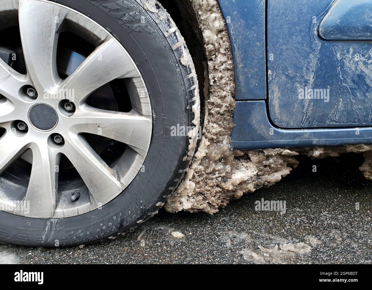 Big frozen snow and ice near wheel and tire under the fender in the ...