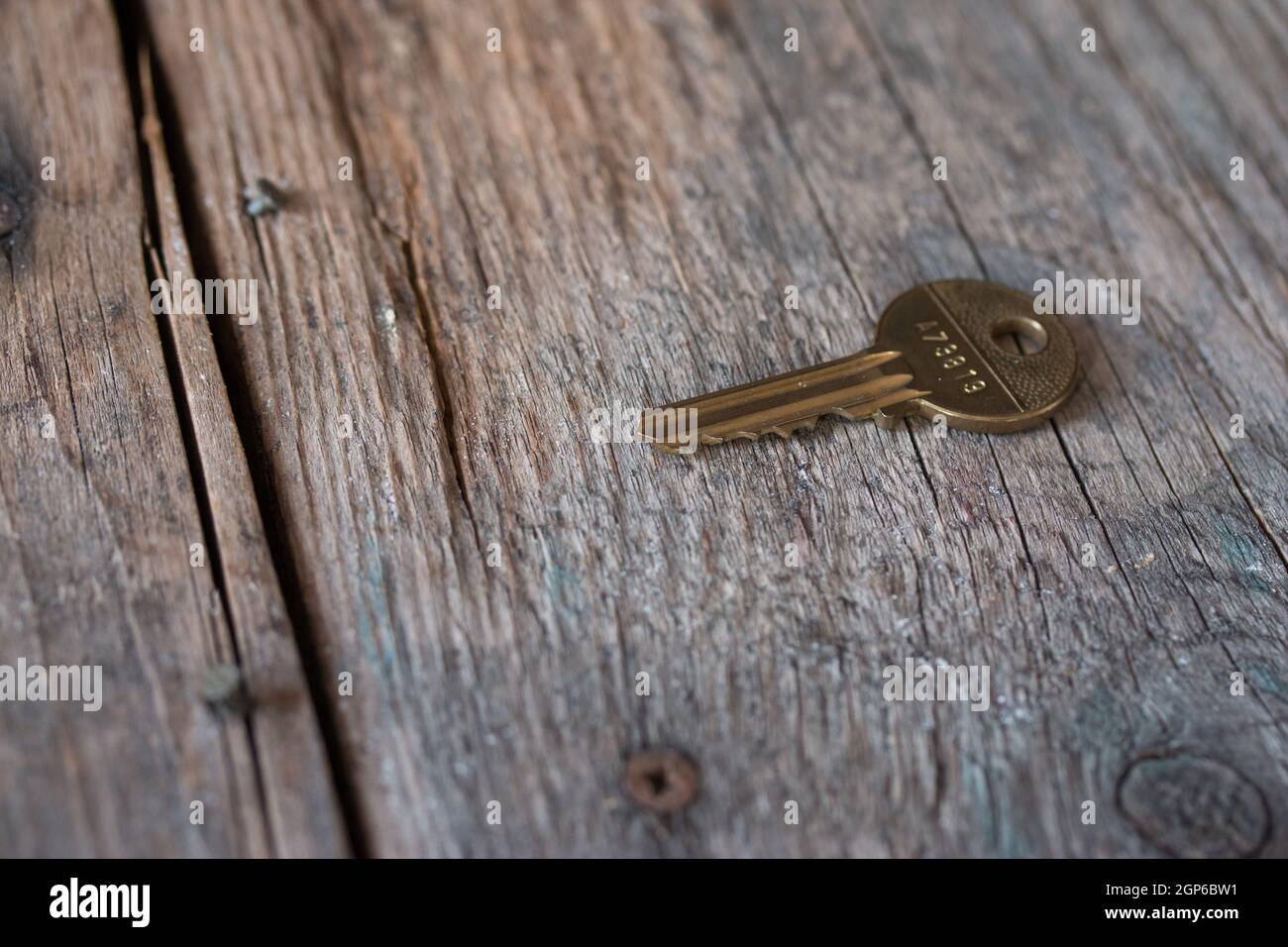Old key is lying on a rustic wooden desk Stock Photo - Alamy