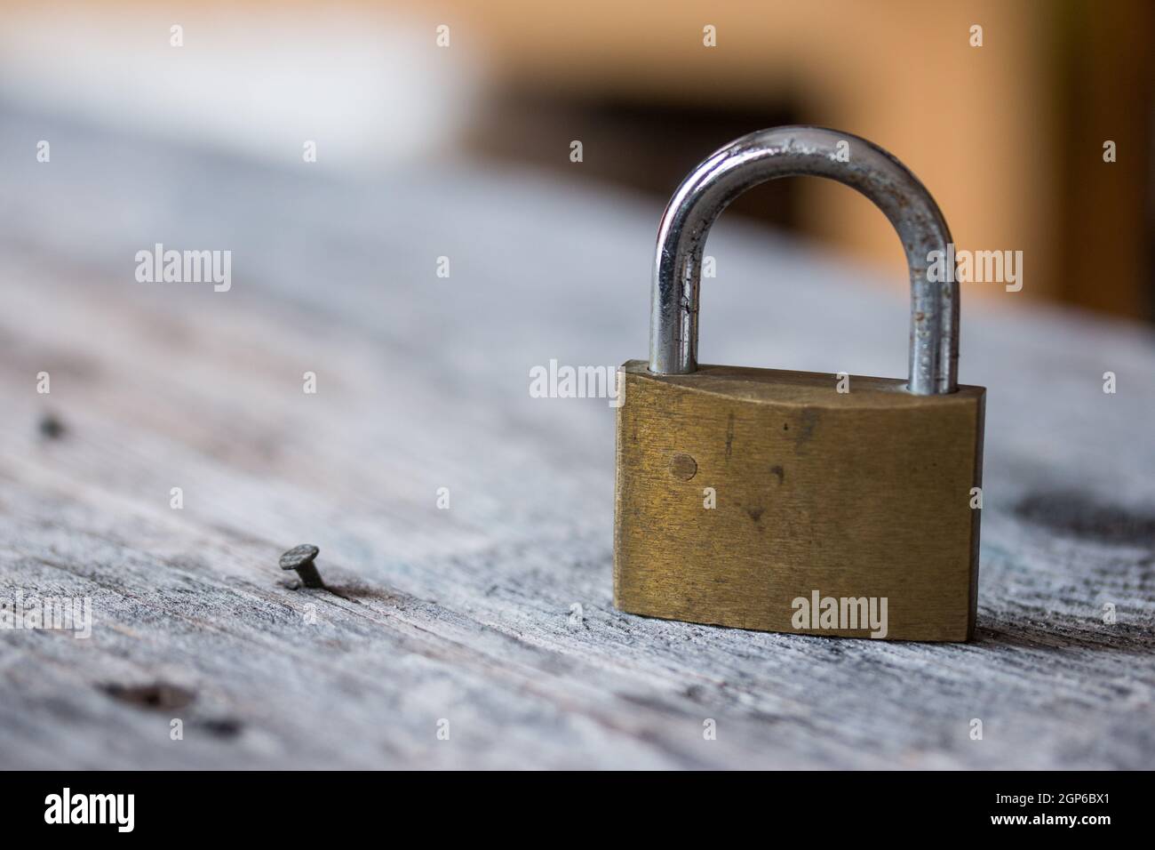 Padlock is lying on rustic wooden desk, close up Stock Photo - Alamy