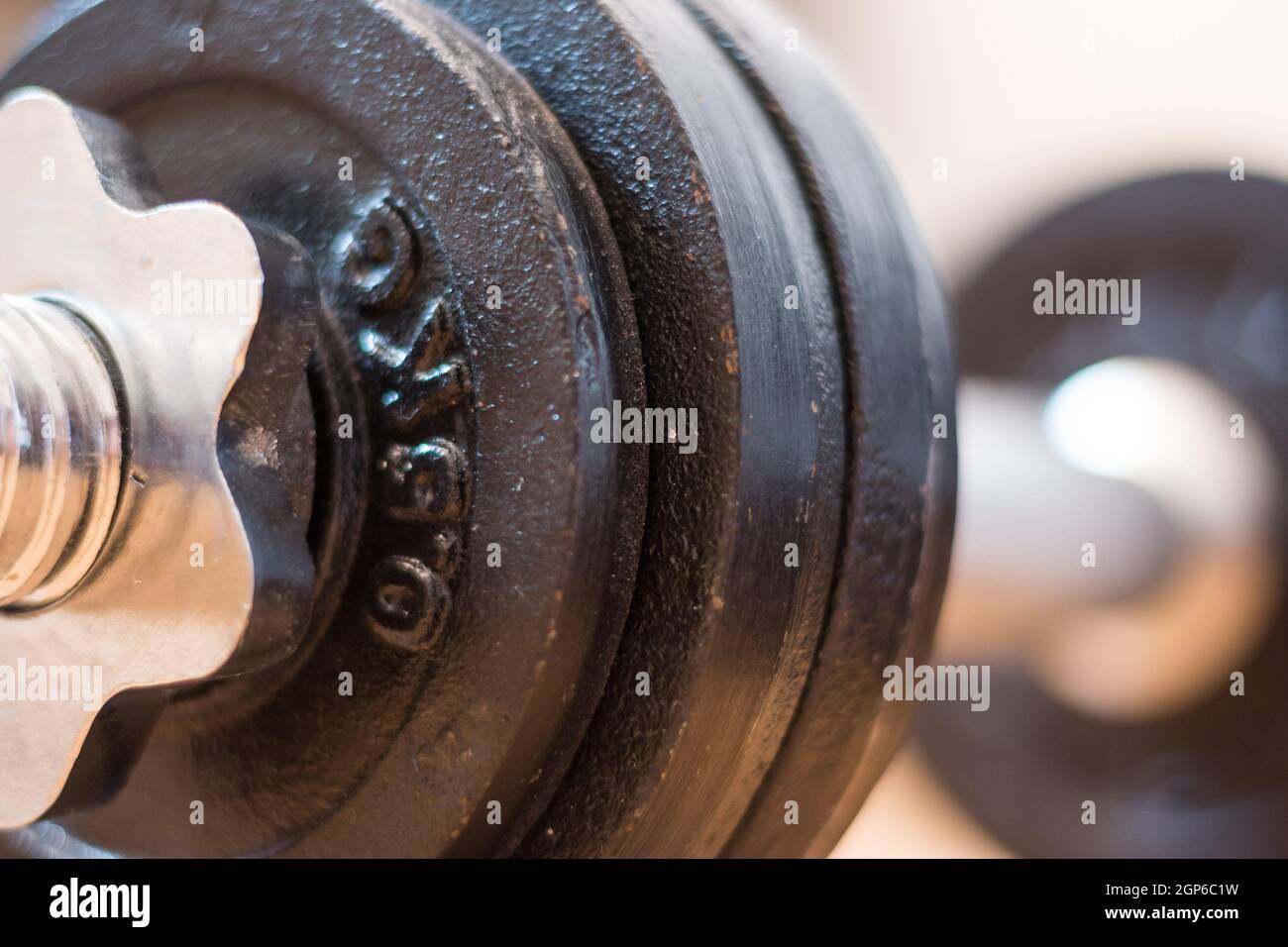 Black bar bell on the wooden floor, physical exercise Stock Photo - Alamy