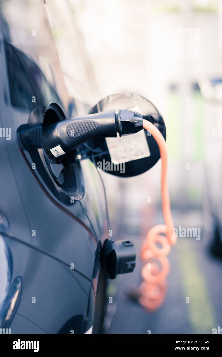 Electric car recharging with charge cable and plug leading to charge ...