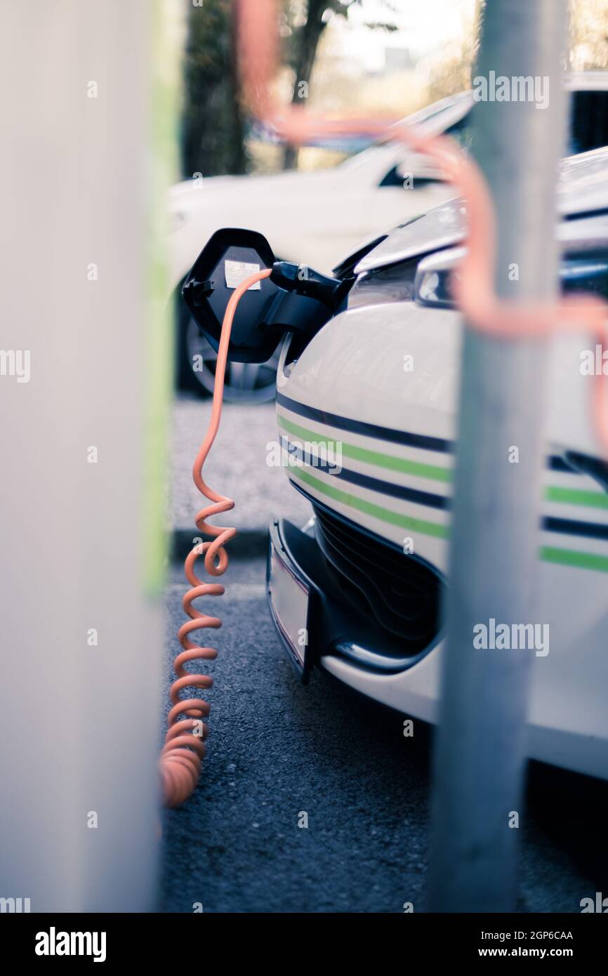 Electric car recharging with charge cable and plug leading to charge ...