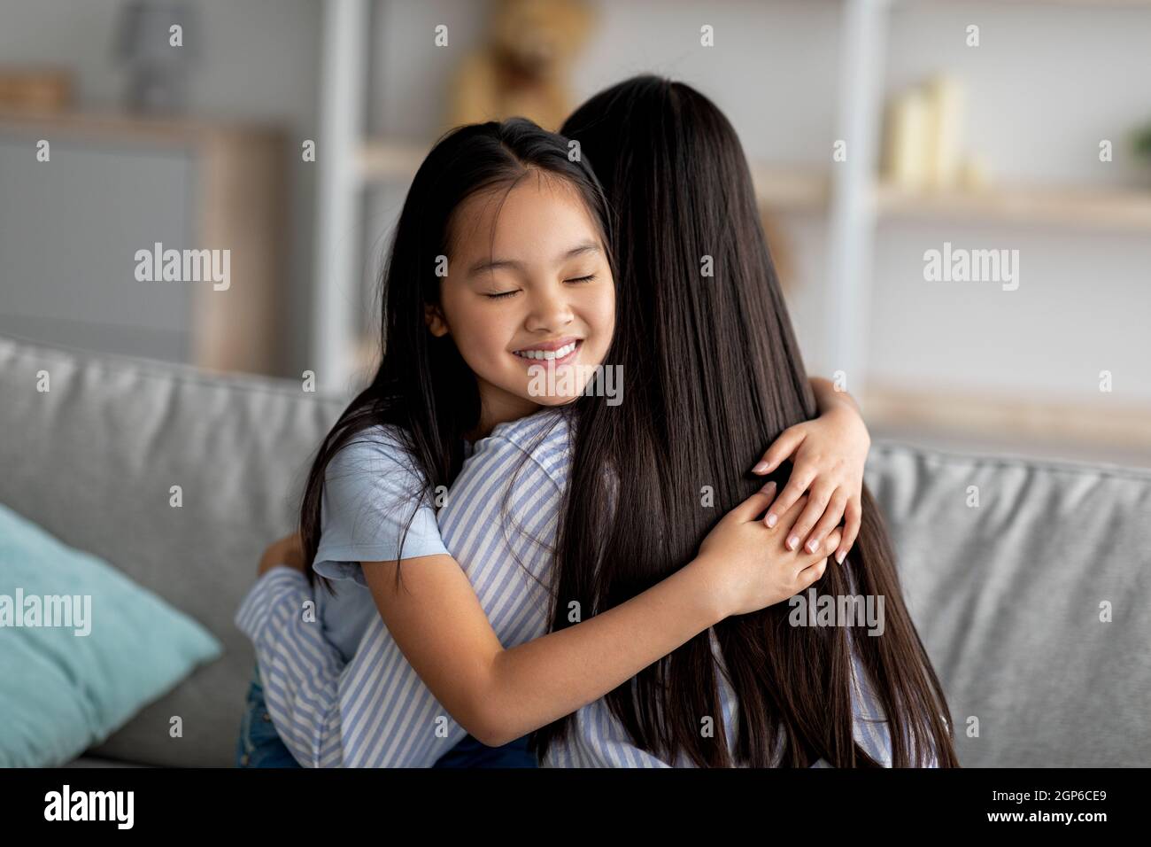 Bonding Concept Cute Asian Girl Hugging Her Mother And Smiling