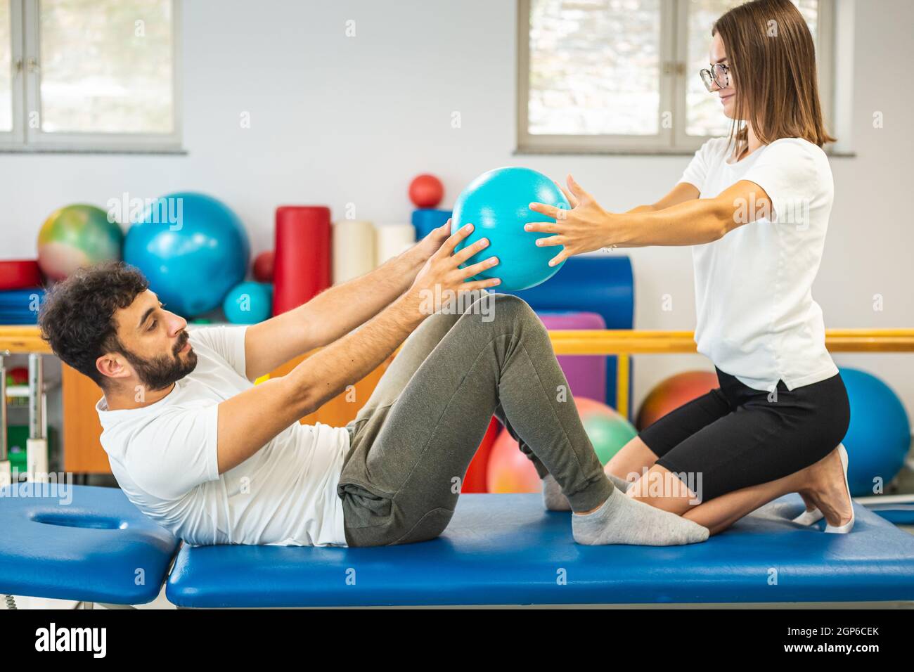 Female Physiotherapist And Male Patient During Rehabilitation Therapy