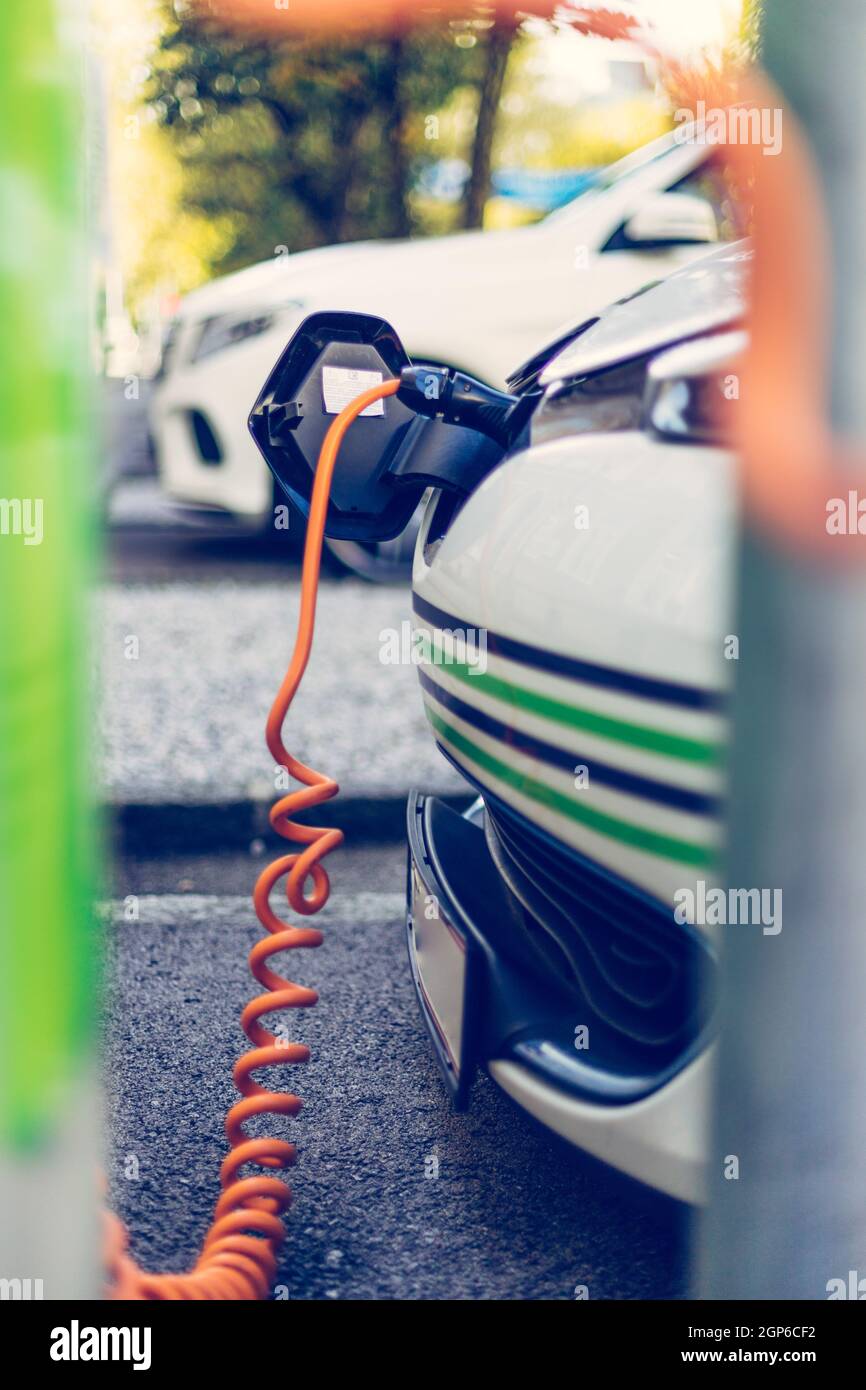 Electric car recharging with charge cable and plug leading to charge ...