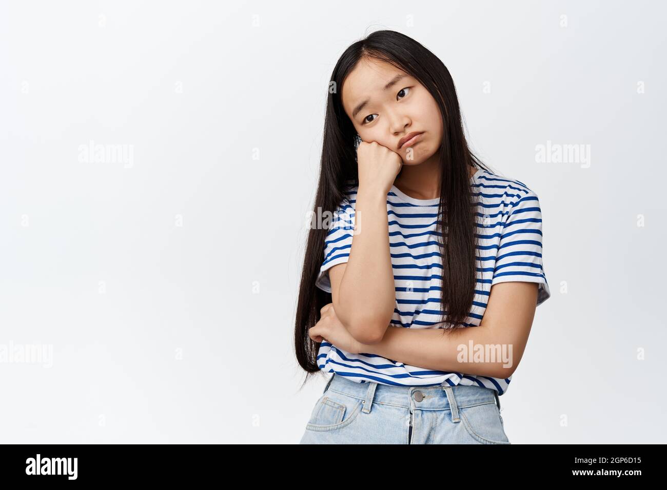 Sad and gloomy asian girl looks lonely, sulking and sighing ...