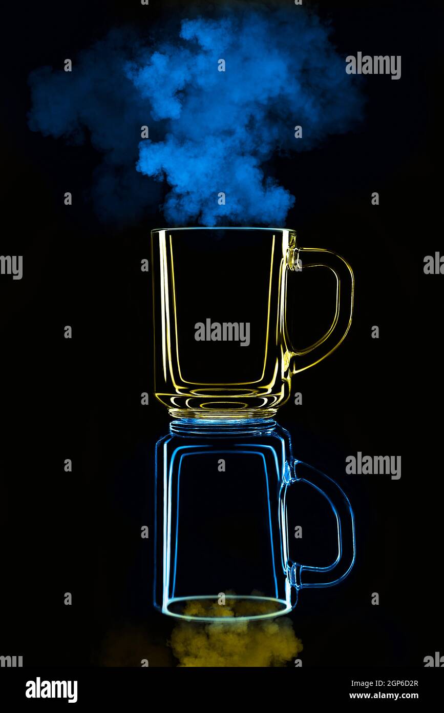 Just a glass on a black background with a reflection. Blue and yellow ...