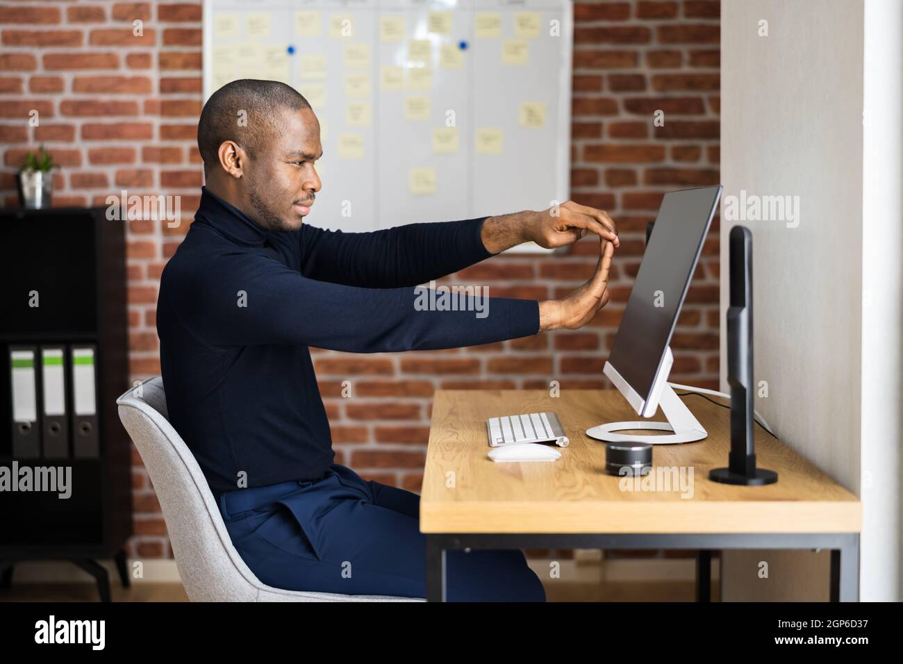 African American Man Doing Stretch Exercise In Office At Work Stock ...