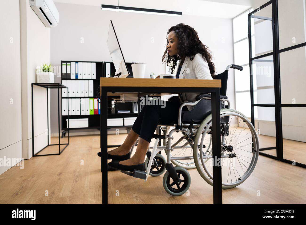 Disabled African Worker In Wheelchair Working On Computer Stock Photo ...