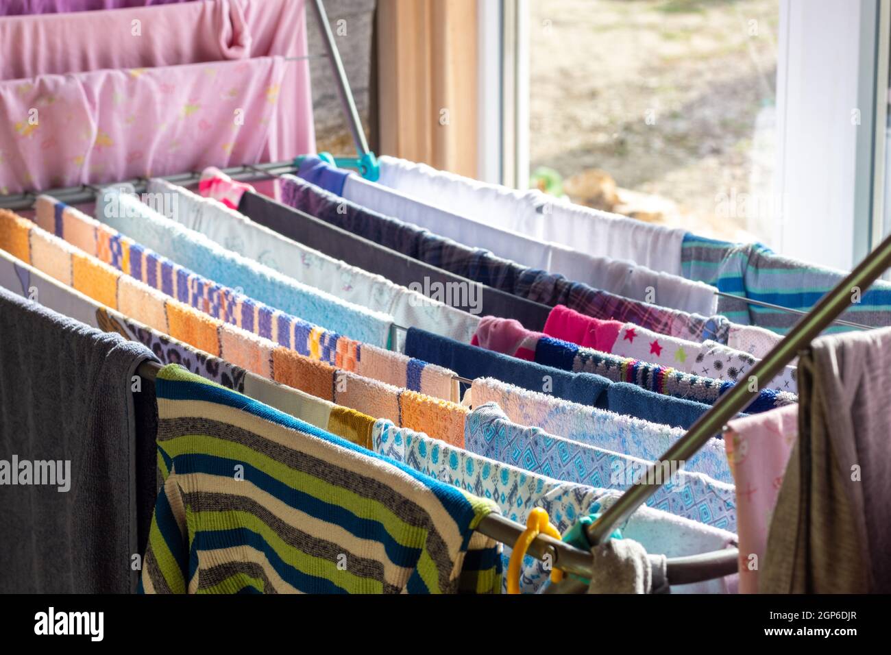 The washed clean linen is dried in a dryer near the window Stock Photo ...
