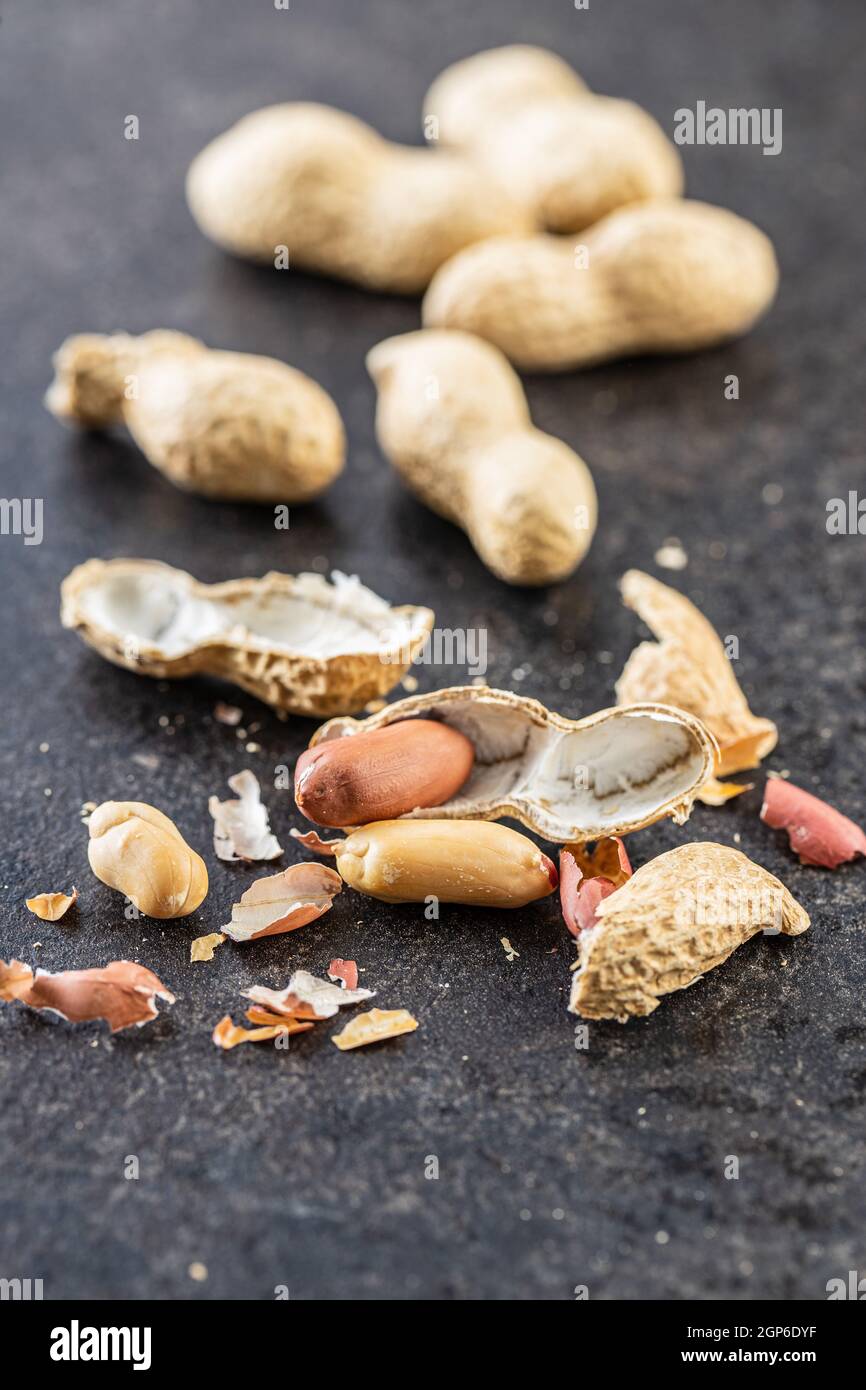 Roasted peanuts. Tasty groundnuts on black table Stock Photo - Alamy
