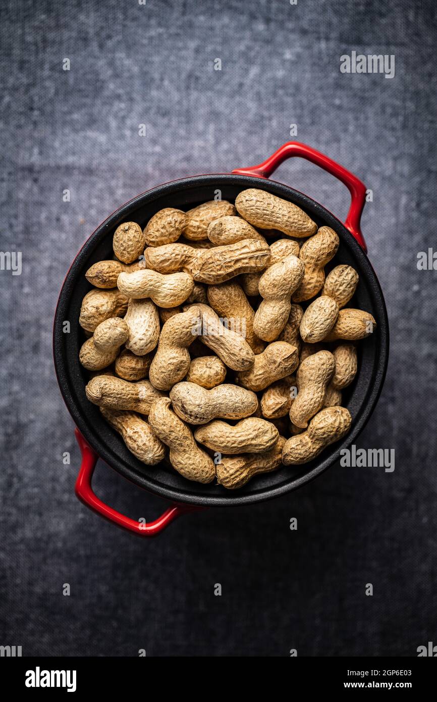 Roasted peanuts. Tasty groundnuts in pot on tablecloth. Top view Stock ...