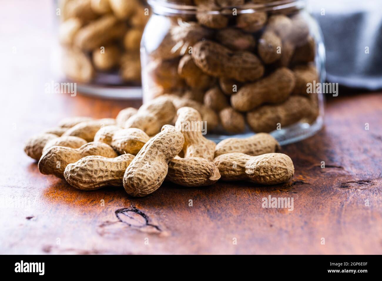 Roasted peanuts. Tasty groundnuts on wooden table Stock Photo - Alamy