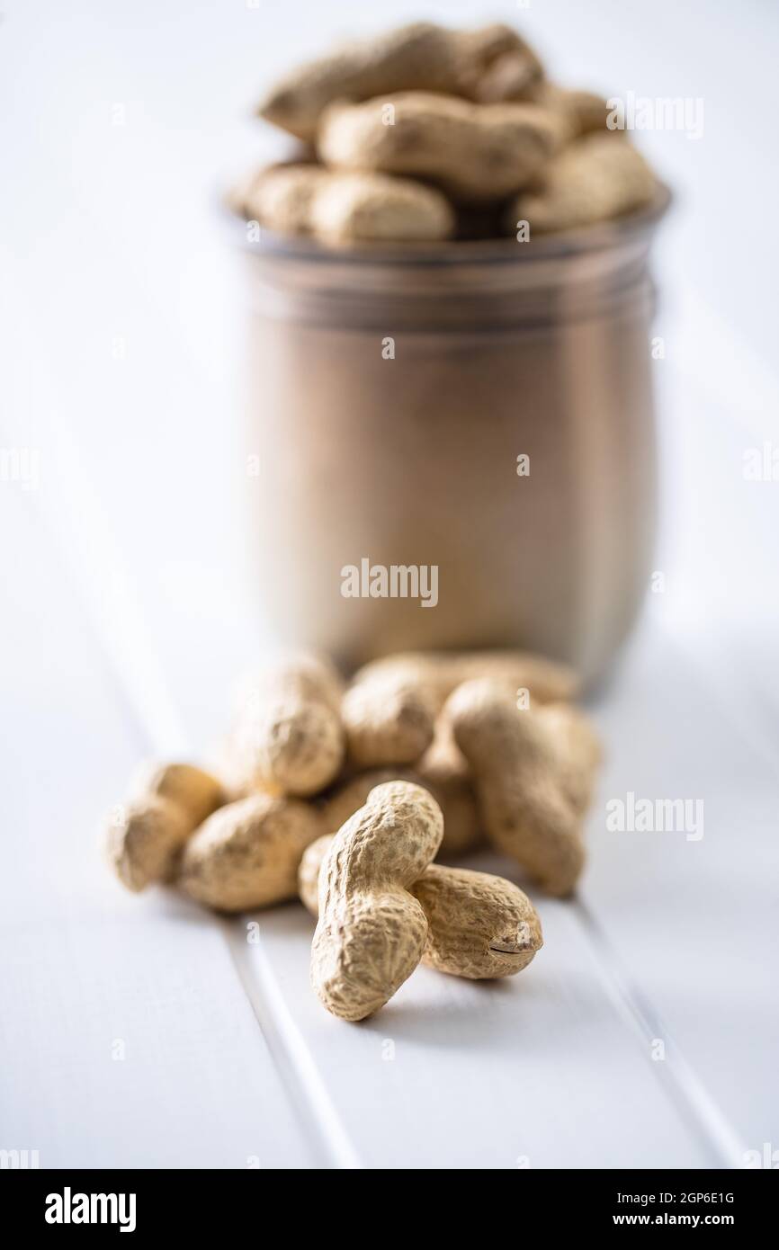 Roasted peanuts. Tasty groundnuts on white table Stock Photo - Alamy